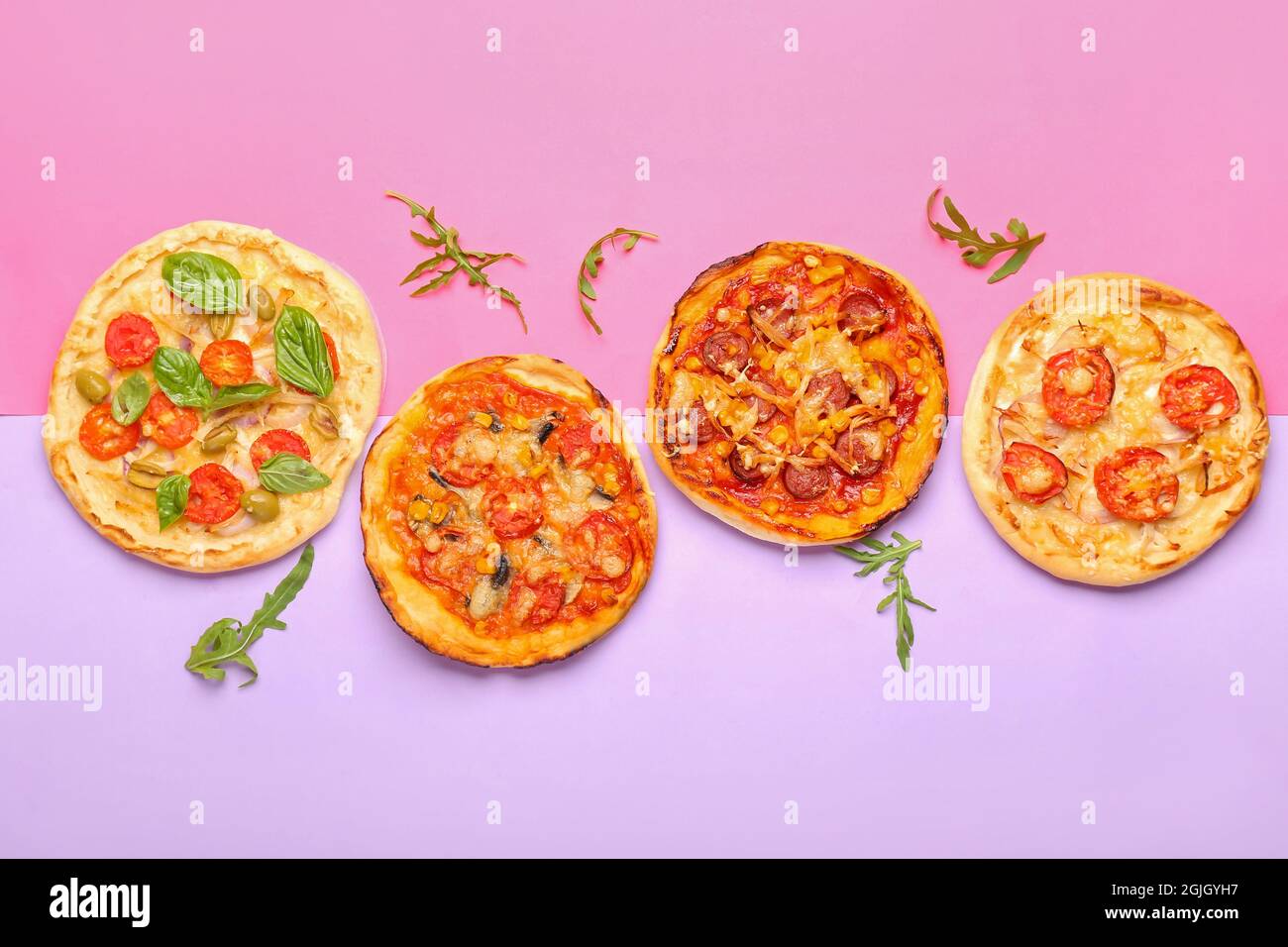Tasty mini pizzas on color background Stock Photo - Alamy