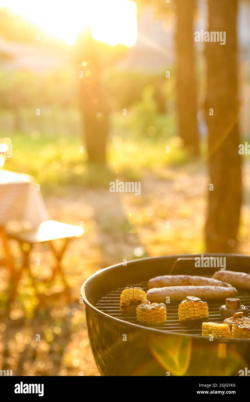Modern barbecue grill with tasty food outdoors Stock Photo - Alamy