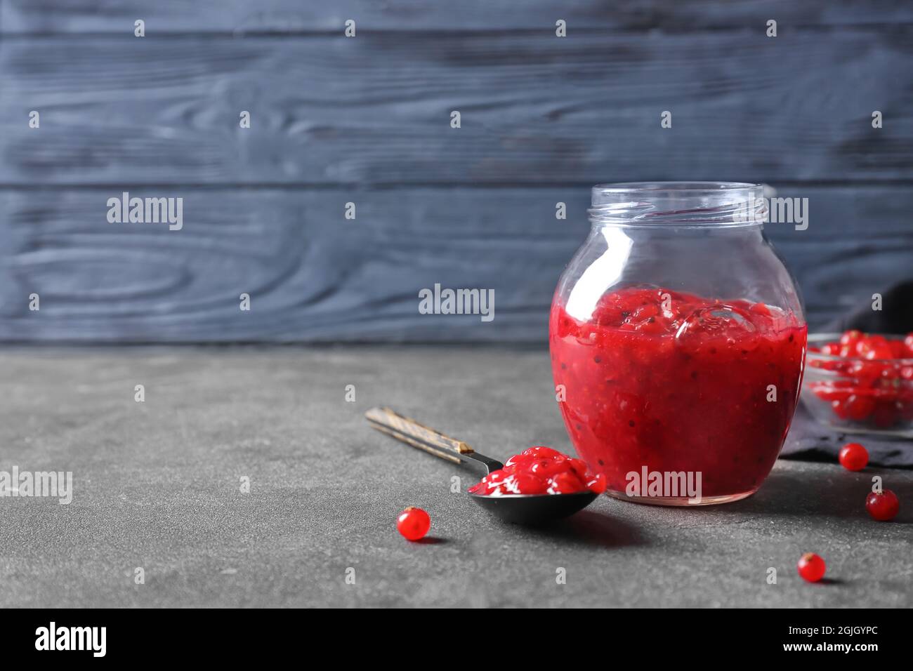 Jar of red currant jam on dark background Stock Photo - Alamy
