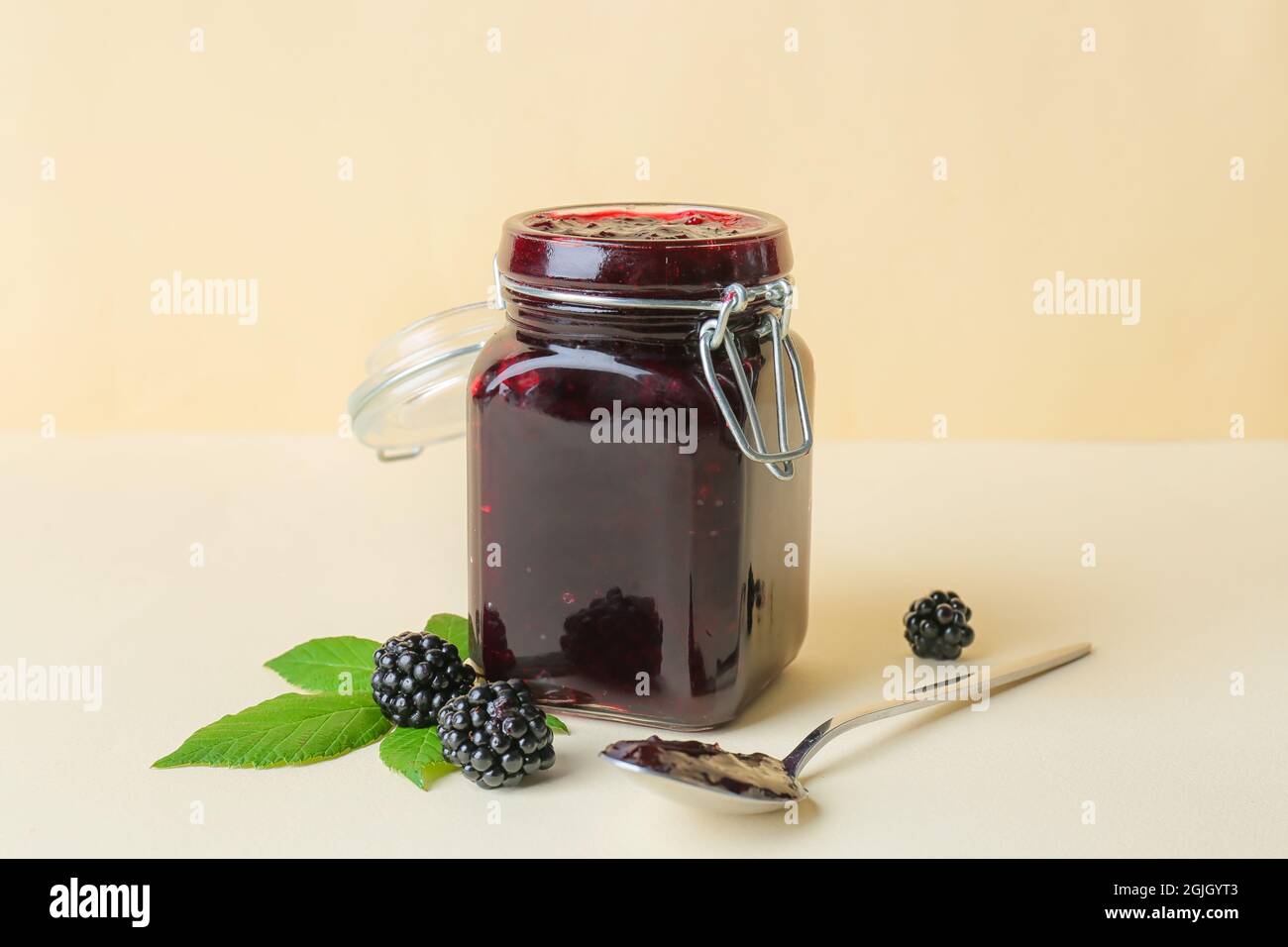 Jar of tasty blackberry jam on color background Stock Photo - Alamy