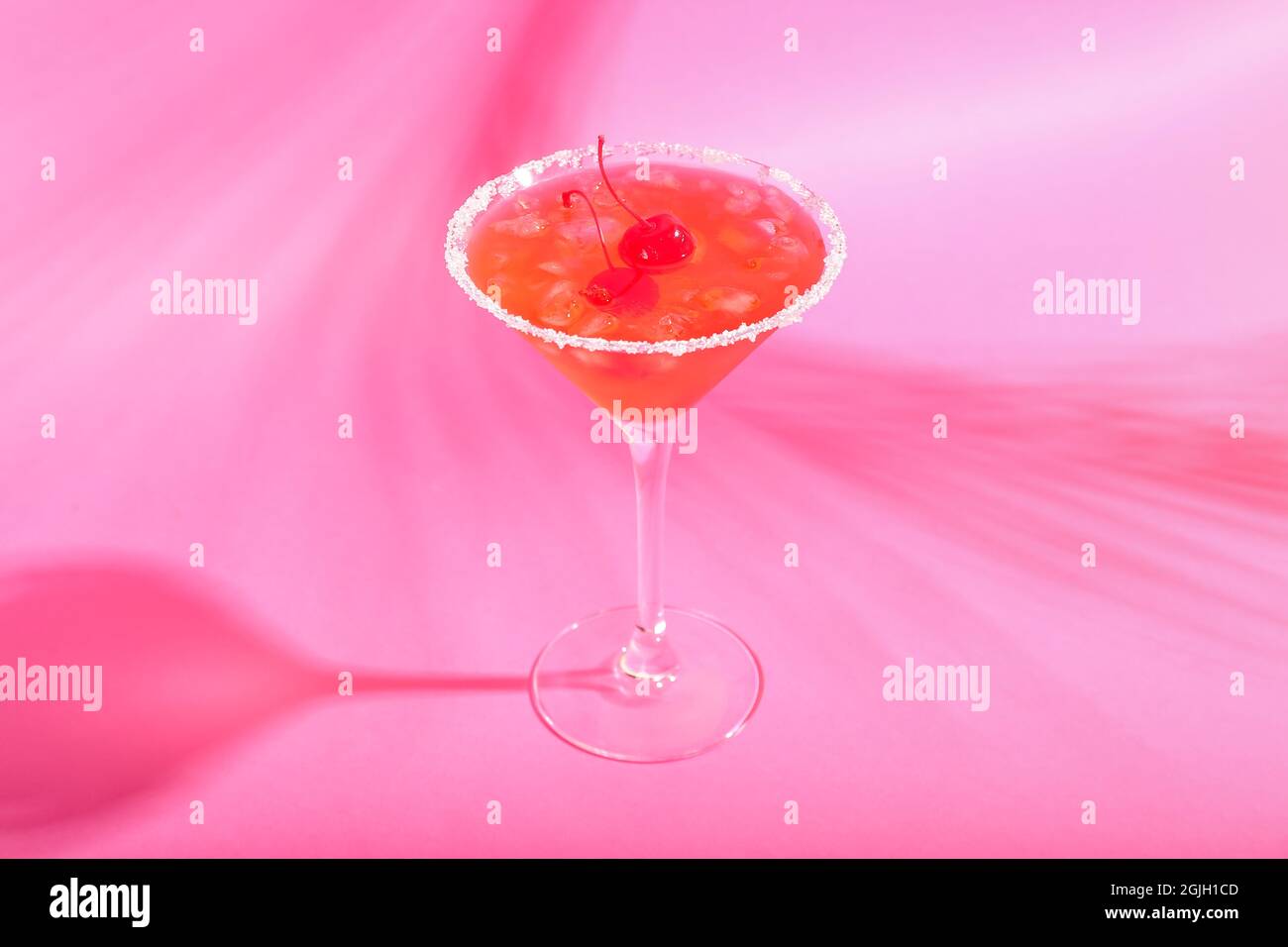 Glass of tasty cosmopolitan cocktail on color background Stock Photo ...