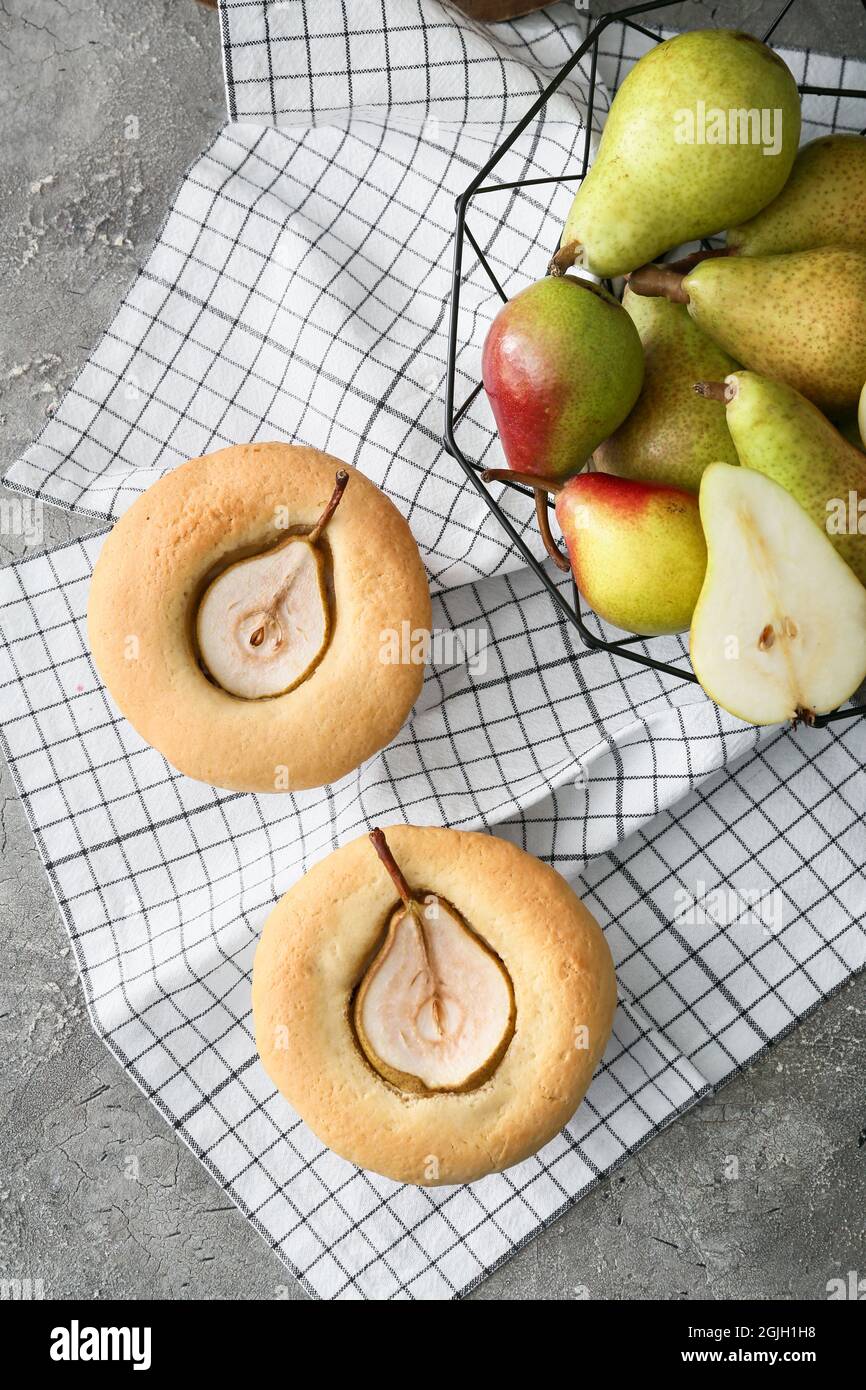 Tasty pear pot pies and fresh fruits on grunge background Stock Photo ...
