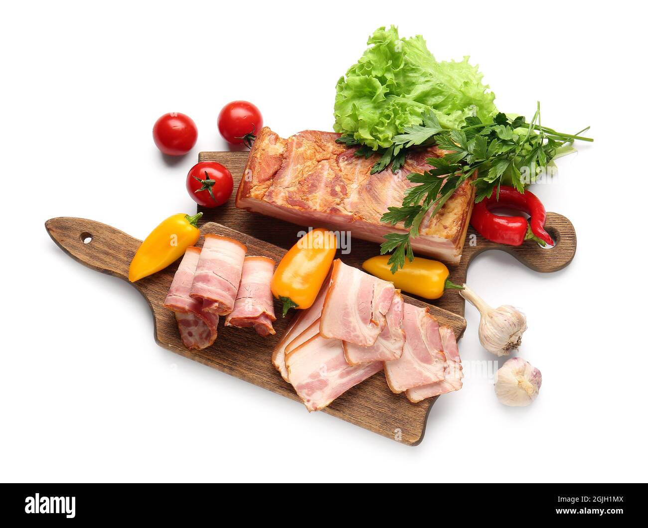 Wooden board with tasty smoked bacon and fresh vegetables on white ...