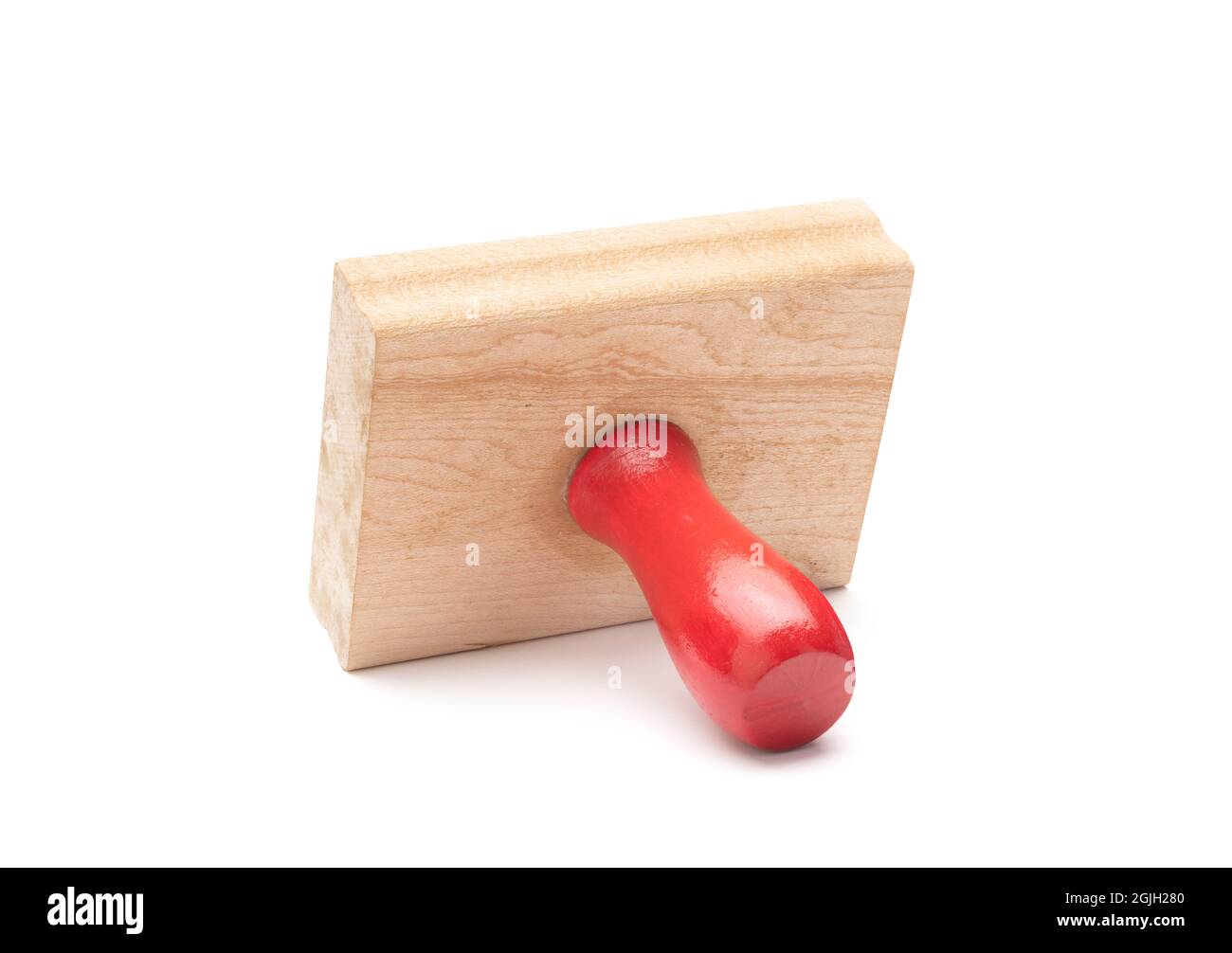 A wooden message stamp with red handle on a white background for use ...