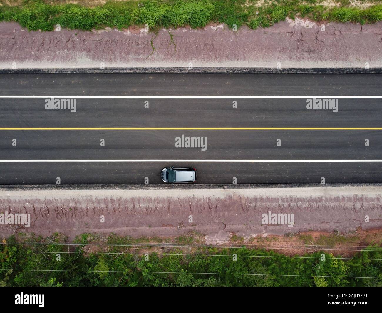Top view of a country road with cars parked on the side of the road ...