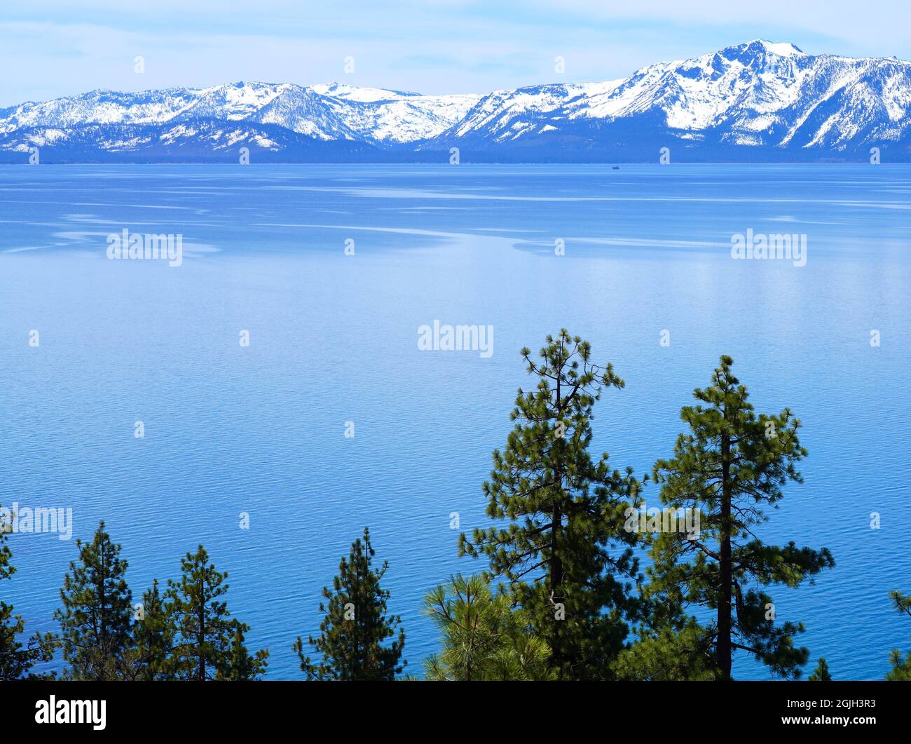 Landscape view of Lake Tahoe with snow-covered mountains and forests ...