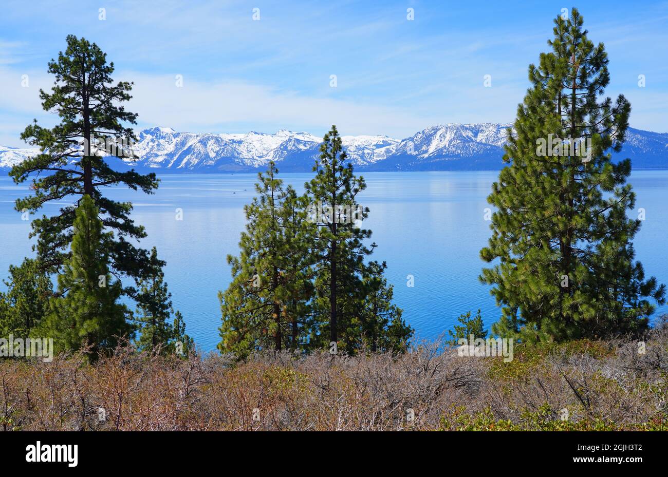 Landscape view of Lake Tahoe with snow-covered mountains and forests ...