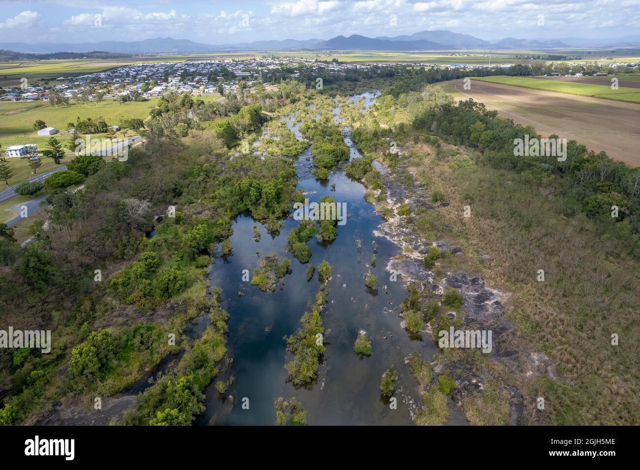 Drone aerial of the Pioneer River Mackay with Marian township in the ...