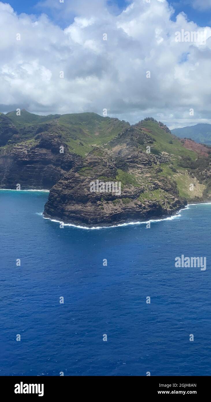 Aerial view of Kauai's eastern shoreline with mountains, cliffs, and ...