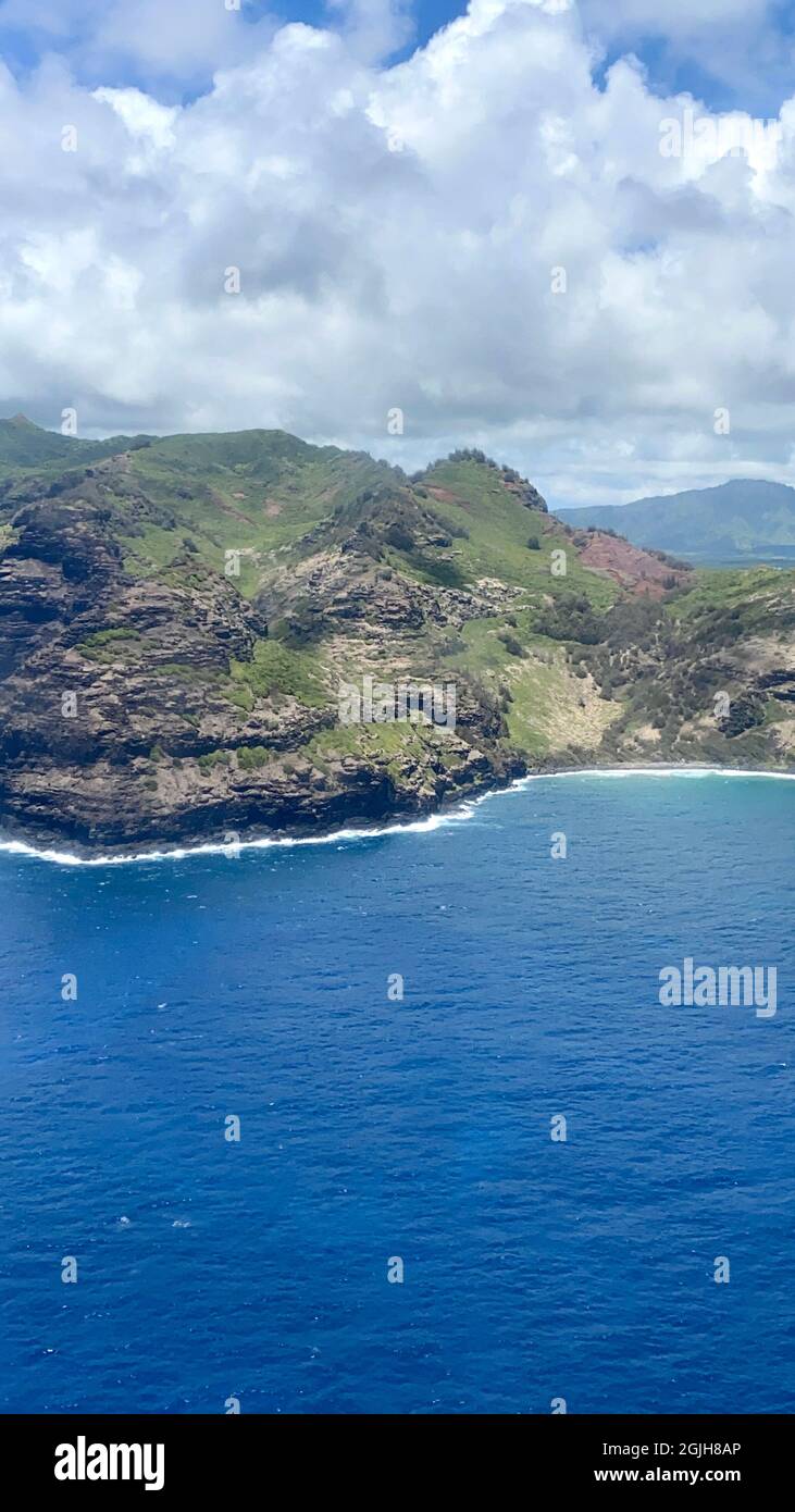 Aerial view of Kauai's eastern shoreline with mountains, cliffs, and ...