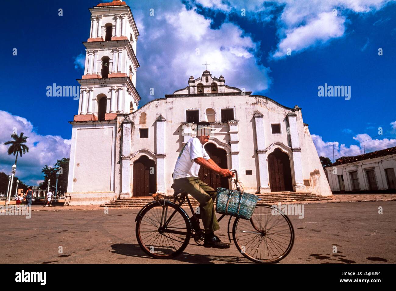 Man on bicycle in front of ther parish Church of San Juan Bautista de Los Remedios, Remedios ...