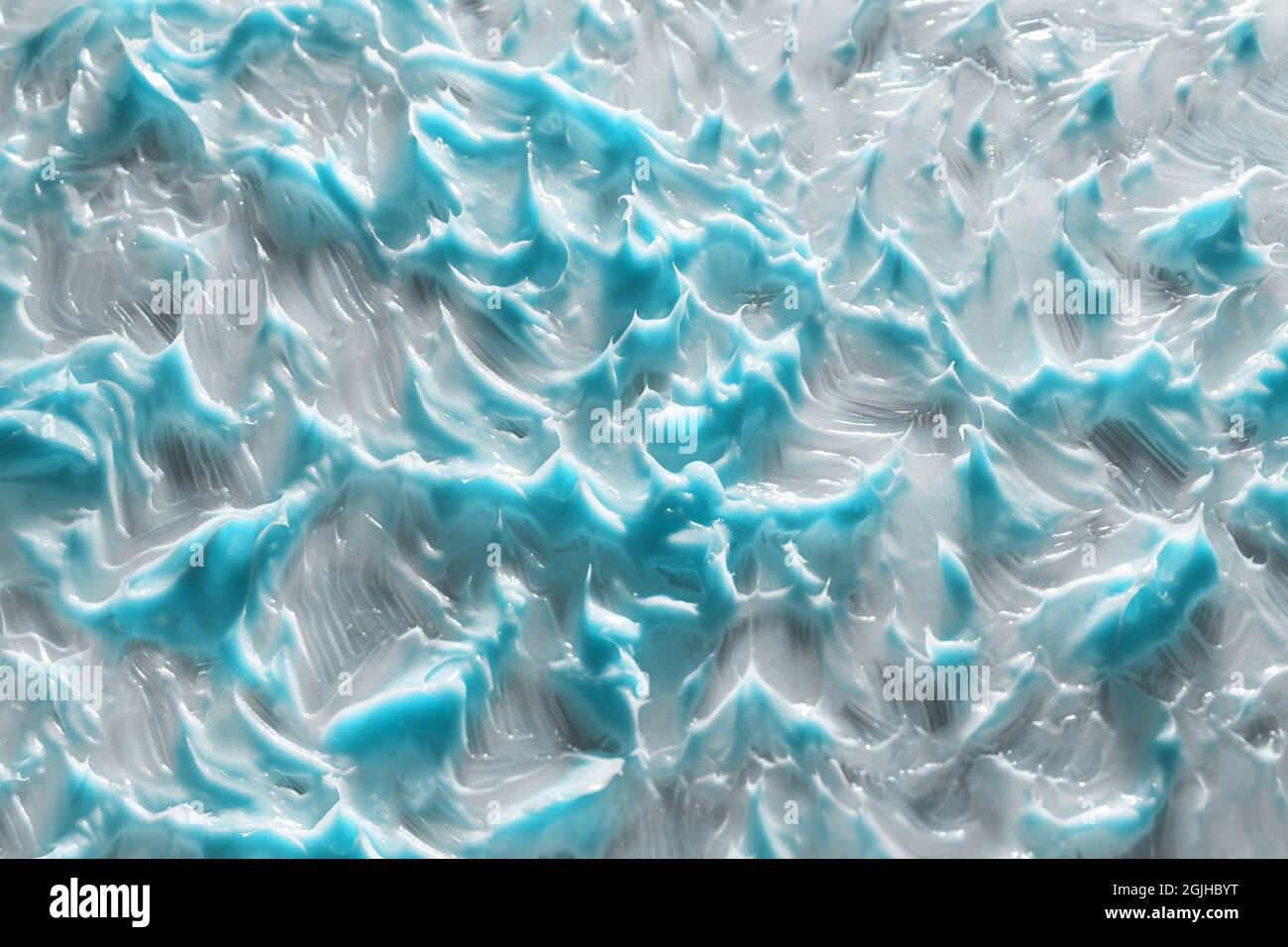 The cosmetic texture of the blue cream. Close-up. Dynamic blue lines ...