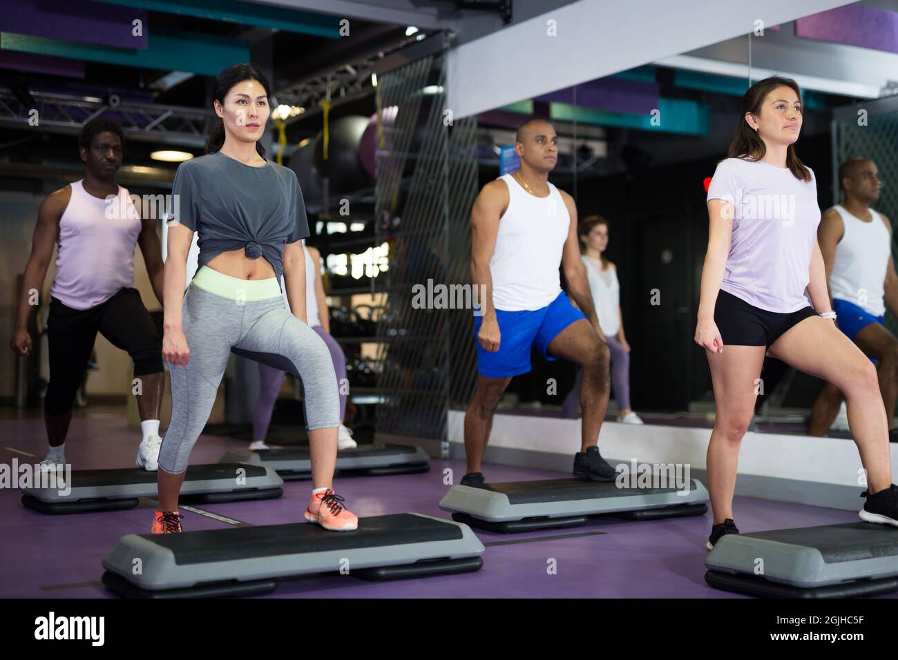 People performing step aerobics in fitness club Stock Photo - Alamy
