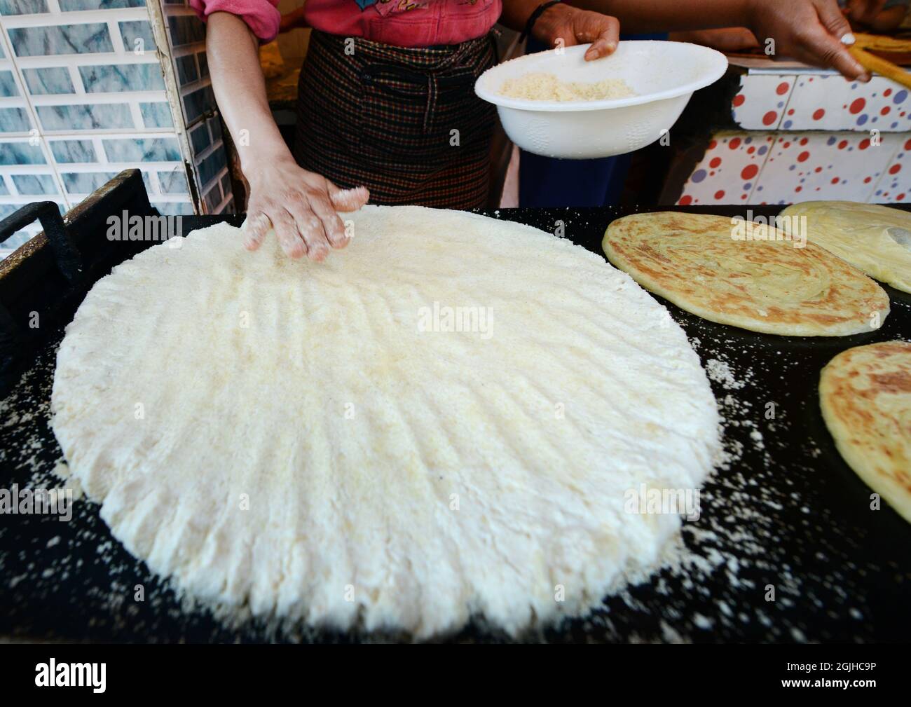 Moroccan women preparing traditional Moroccan bread in a small shop at ...