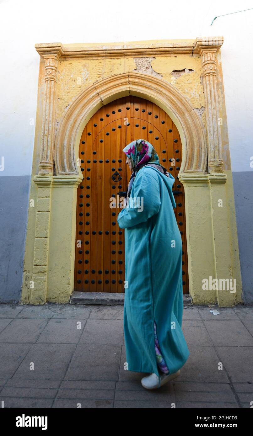 A Moroccan woman dressed in Jalaba walking the the old medina of Salé ...