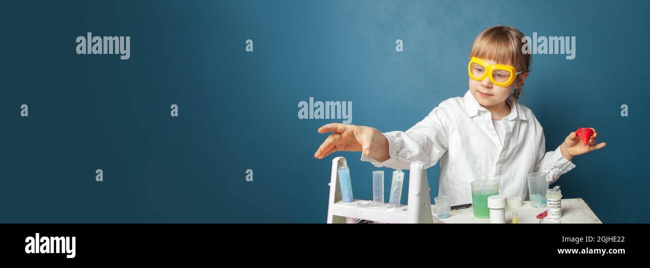 Young kid testing chemistry lab experiment on blue banner background ...
