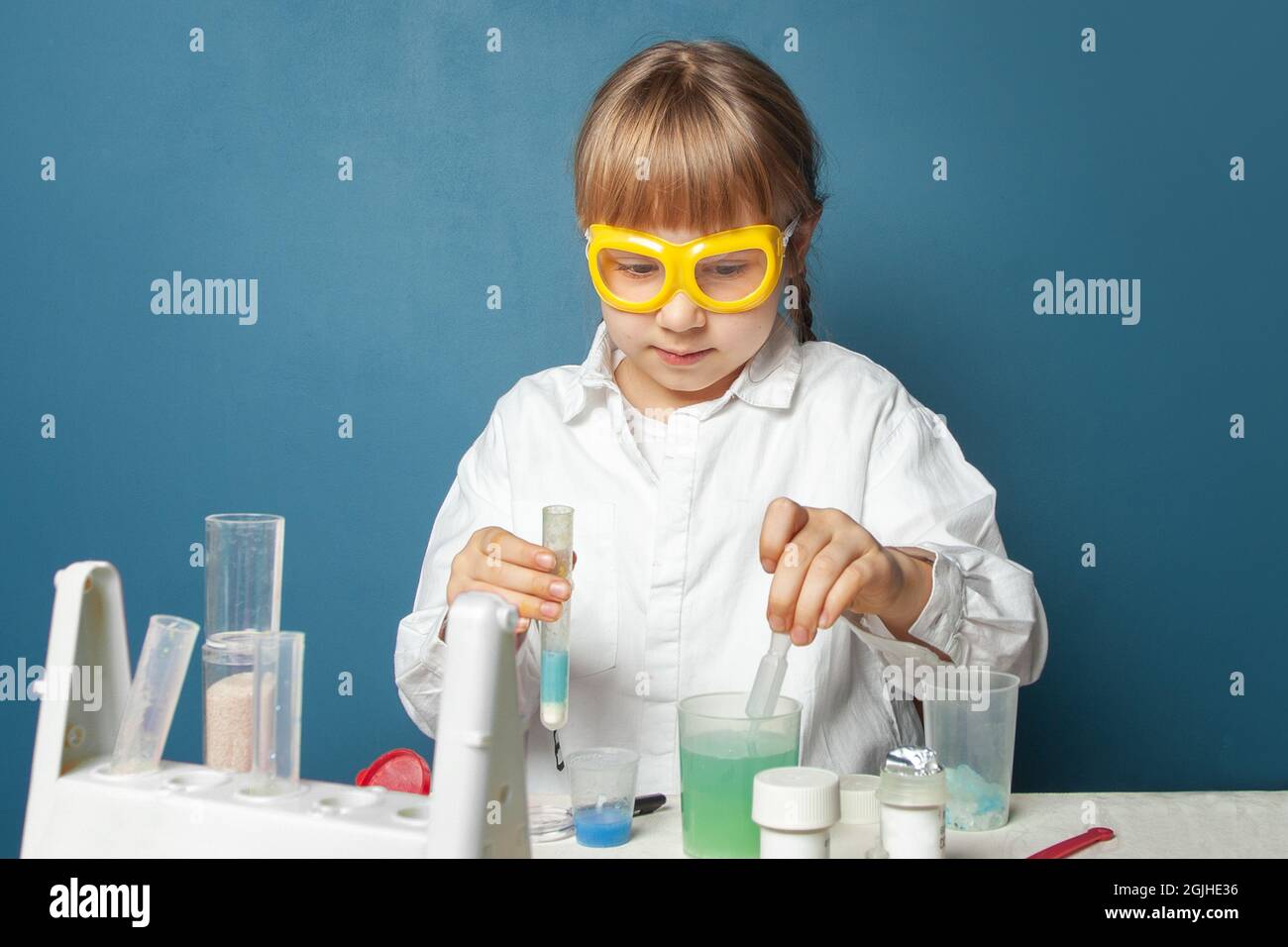 Clever schoolgirl enjoying science experiment. Science and education ...
