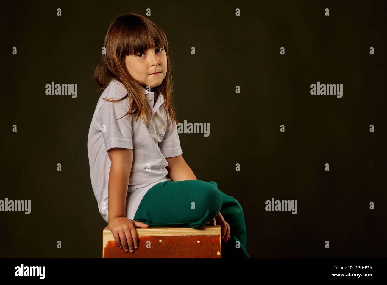 studio portrait of a 5-year-old girl in the uniform of the Juniors ...