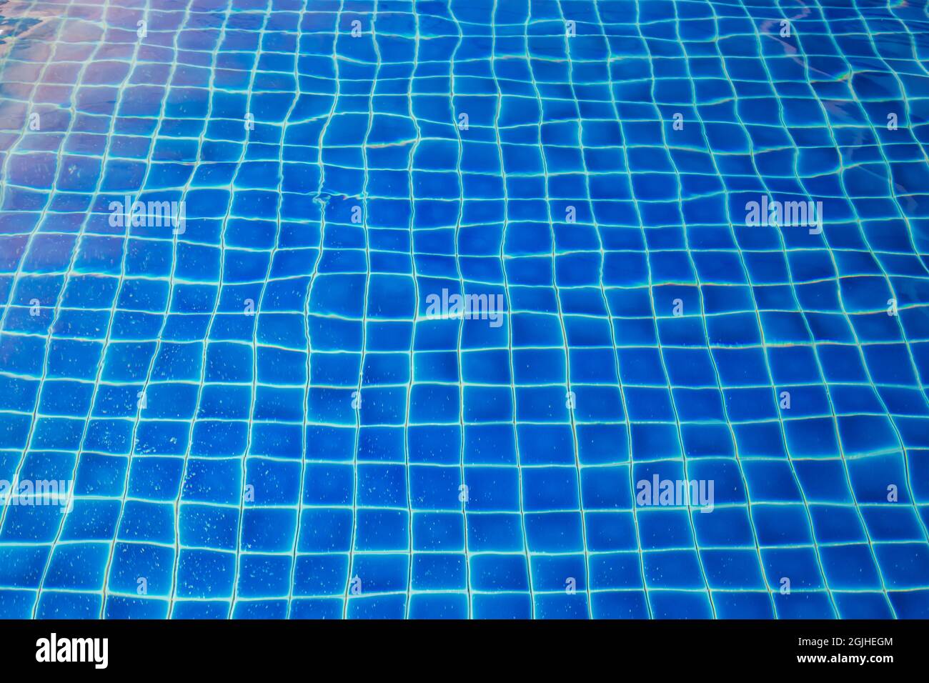 swimming pool sun reflection with blue mosaic background Stock Photo ...