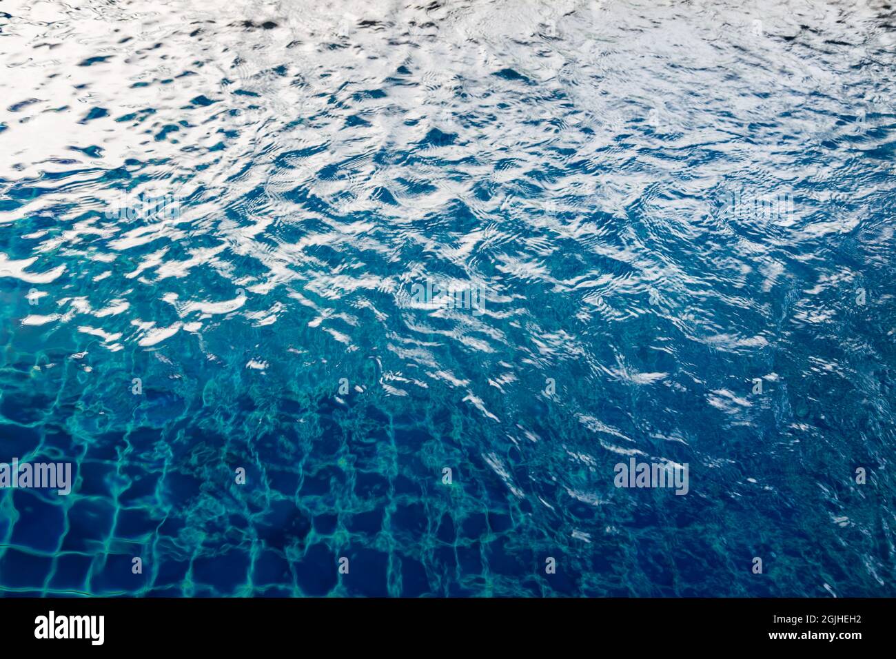 swimming pool sun reflection with blue mosaic background Stock Photo ...