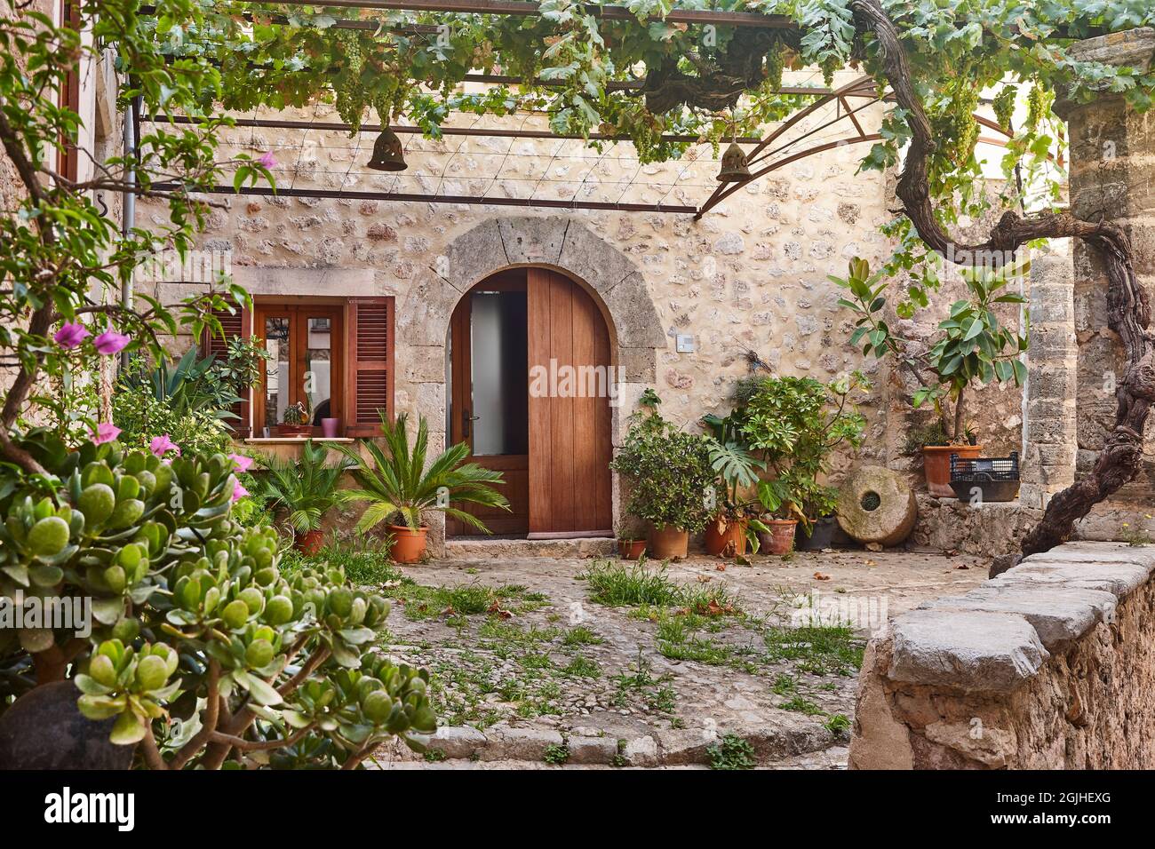 Traditional stone patio surrounded by plants in Mallorca, Balearic ...