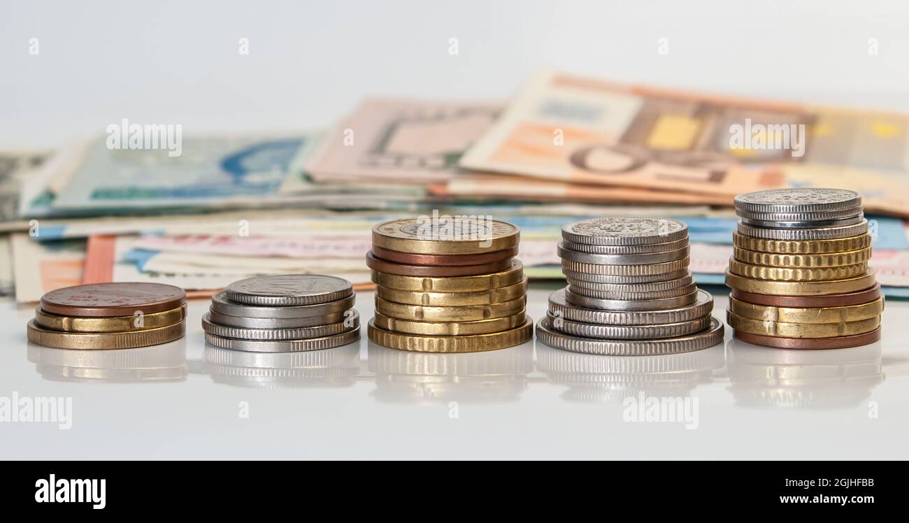 coins and banknotes of different currencies on white background with ...