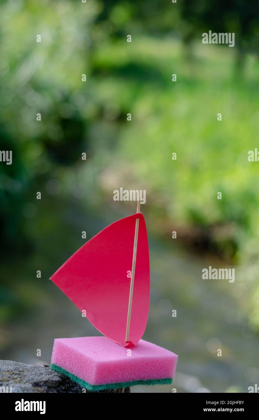 Pink sailboat made from kitchen sponge. A children's boat agains Stock ...