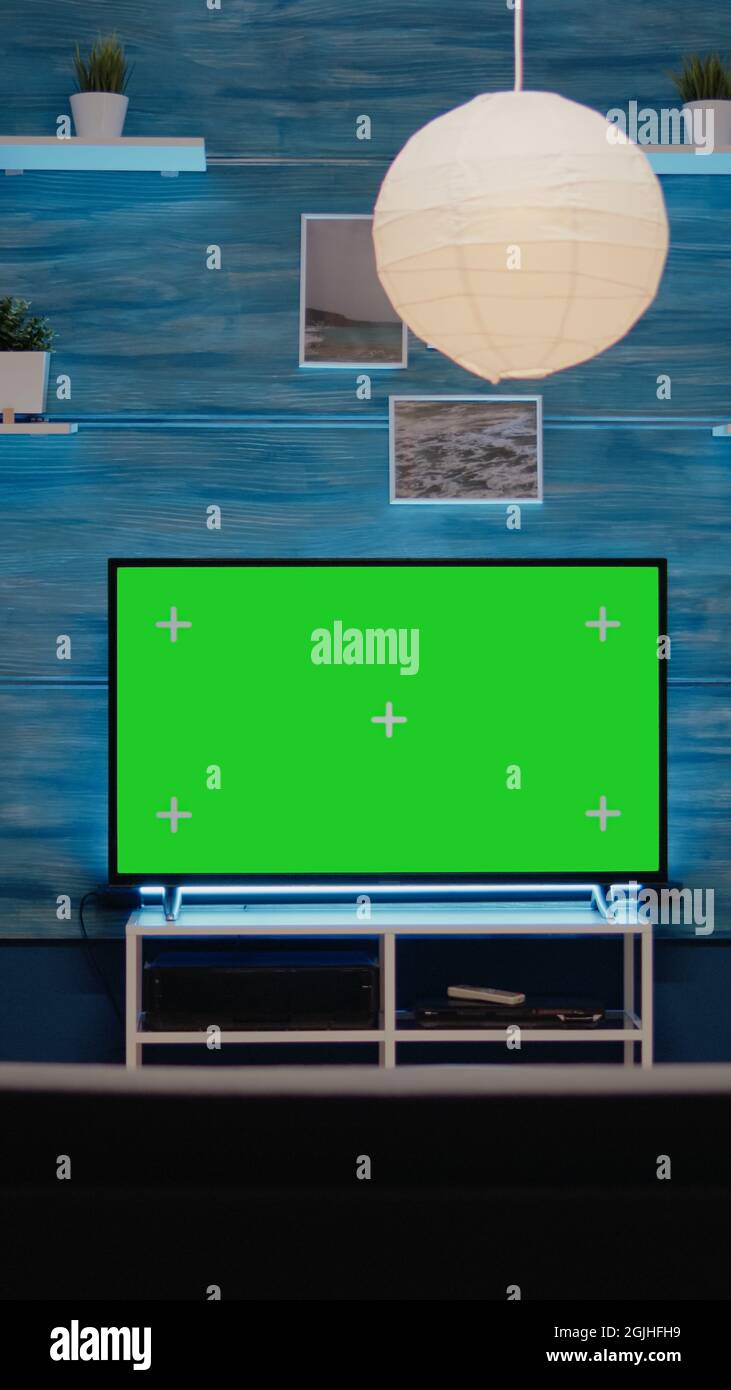 Empty modern room designed with green screen on tv at home. Nobody in ...