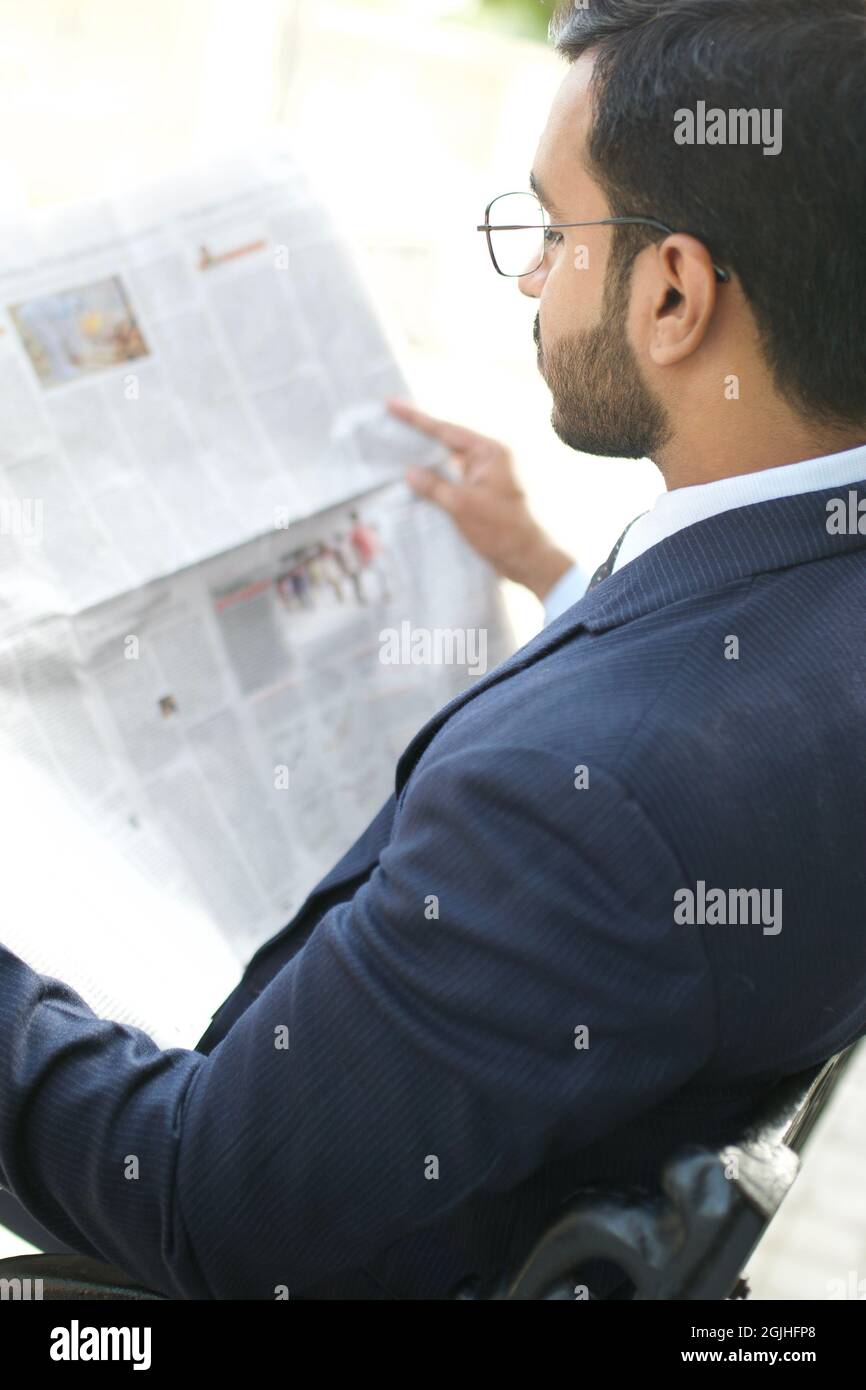 A man reads newspaper Stock Photo - Alamy
