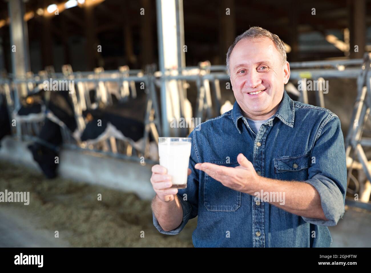 Man is standing with glass of milk Stock Photo - Alamy