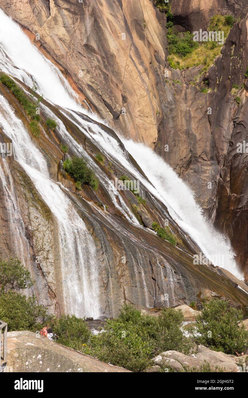 The river flows abruptly into a small lake and over a drop, creating a ...
