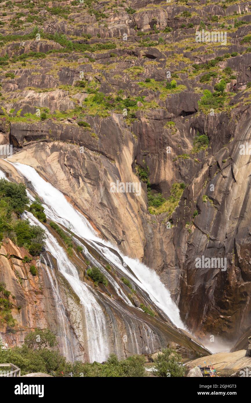 The river flows abruptly into a small lake and over a drop, creating a ...