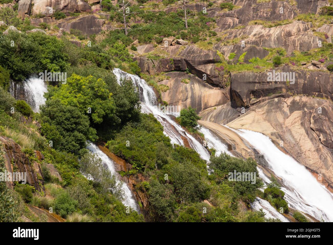 The river flows abruptly into a small lake and over a drop, creating a ...