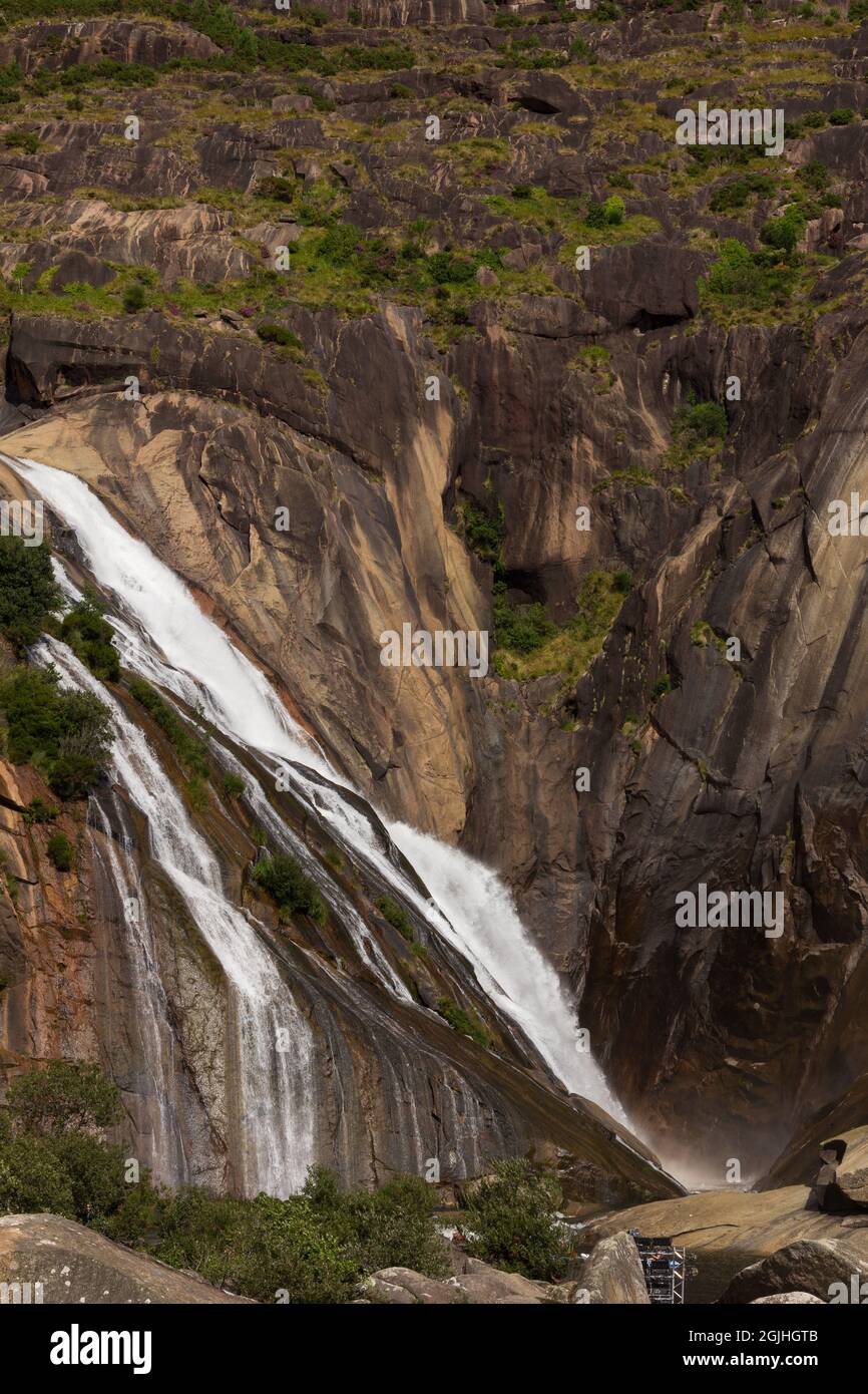 The river flows abruptly into a small lake and over a drop, creating a ...
