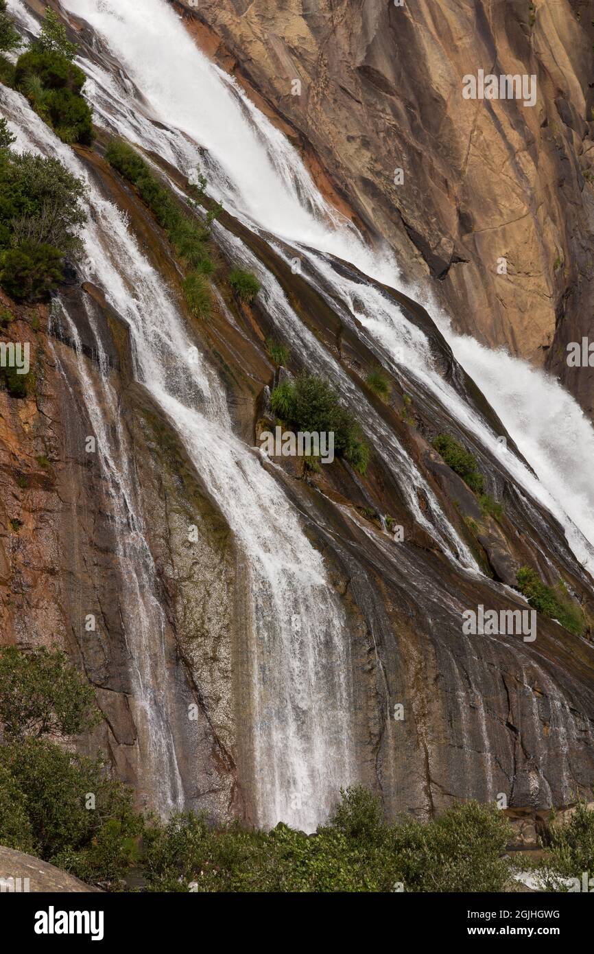 The river flows abruptly into a small lake and over a drop, creating a ...