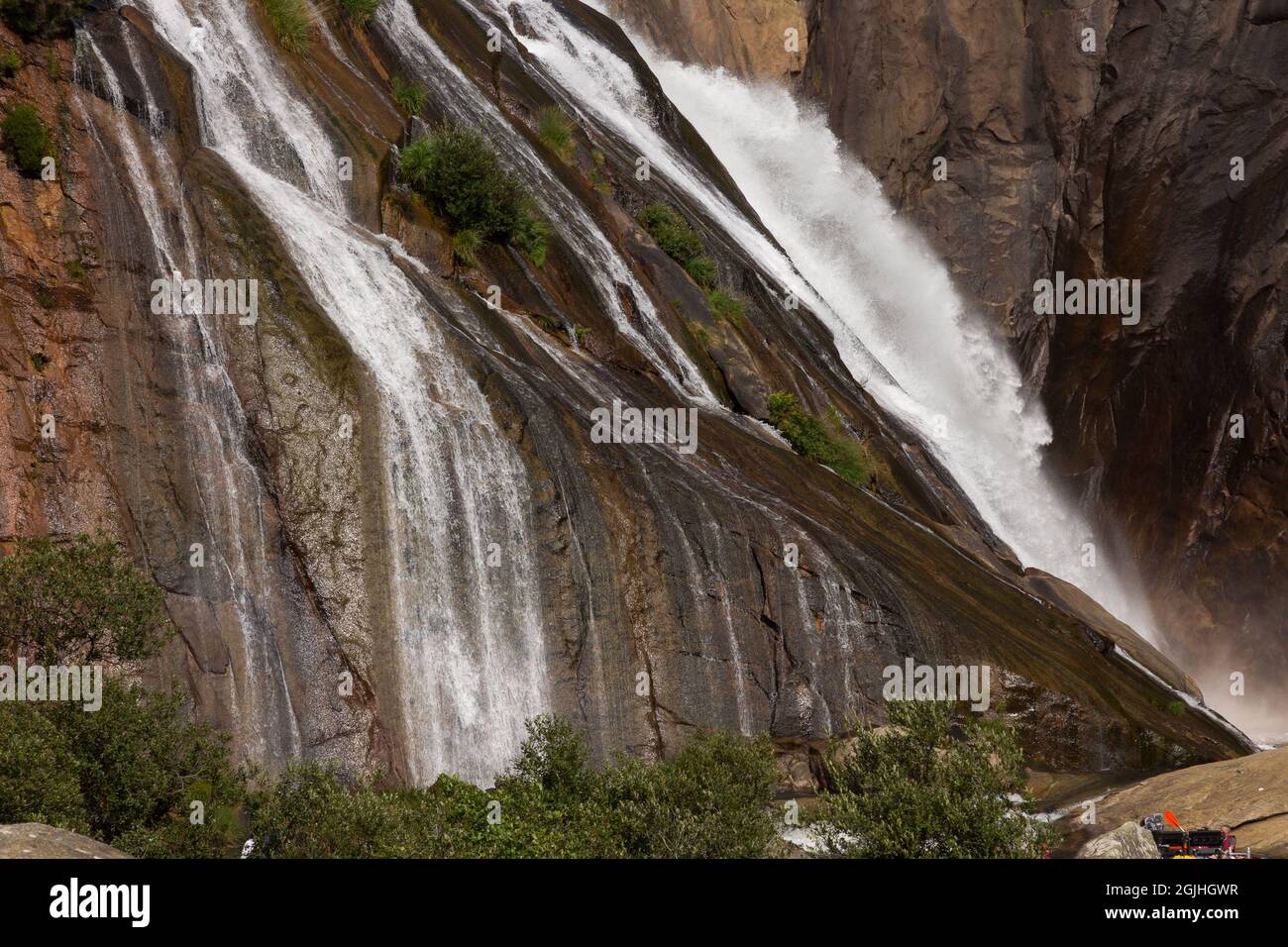 The river flows abruptly into a small lake and over a drop, creating a ...