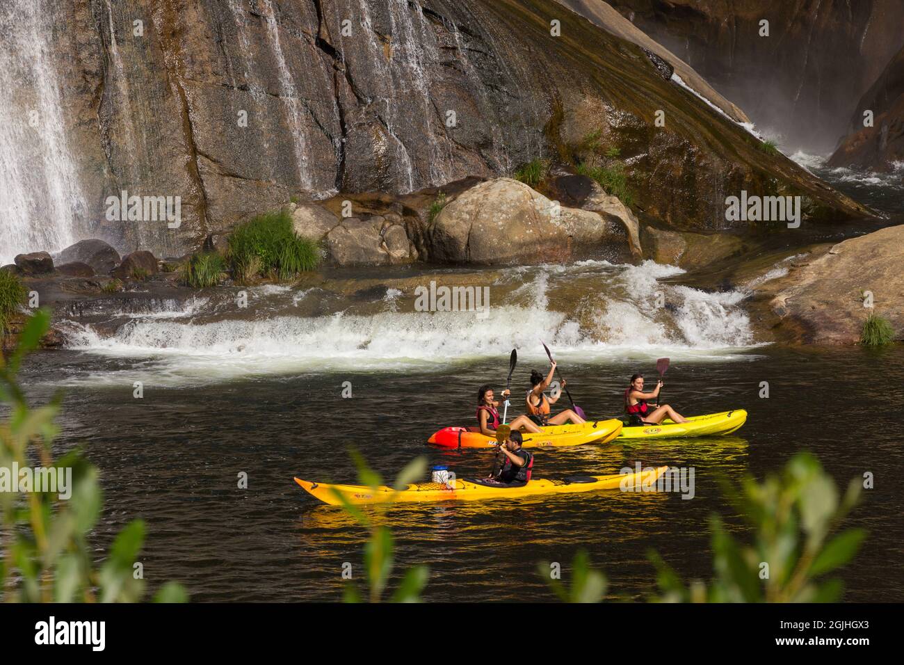 The river flows abruptly into a small lake and over a drop, creating a ...