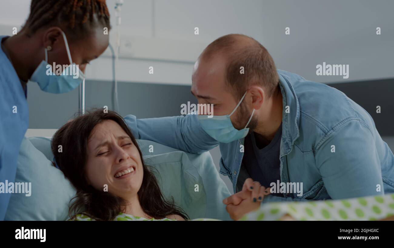 Caucasian pregnant woman giving birth to child in painful labor. Young ... Caucasian pregnant woman giving birth to child in painful labor. Young ...