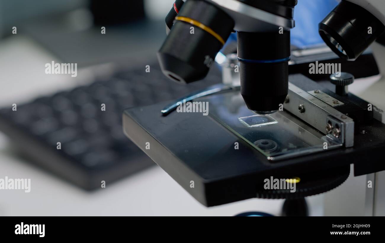Close up of glass tray on microscope for examination in laboratory ...