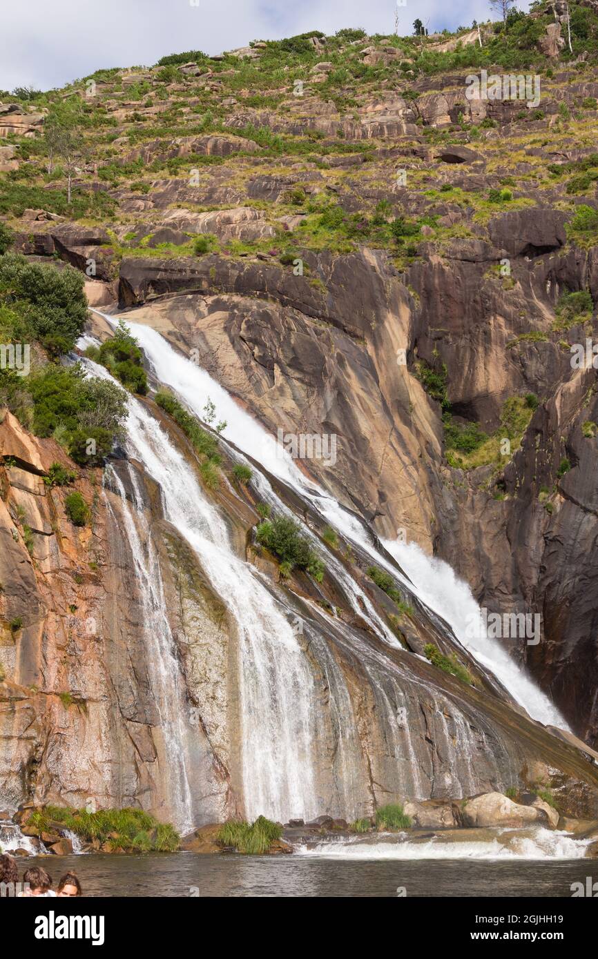 The river flows abruptly into a small lake and over a drop, creating a ...