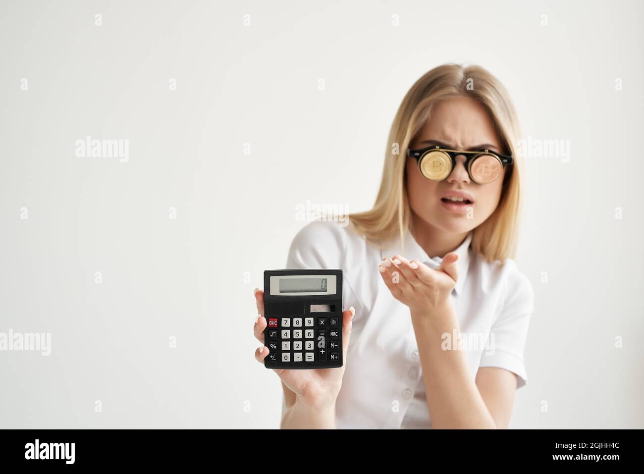 pretty woman calculator in hand and bitcoin light background Stock ...