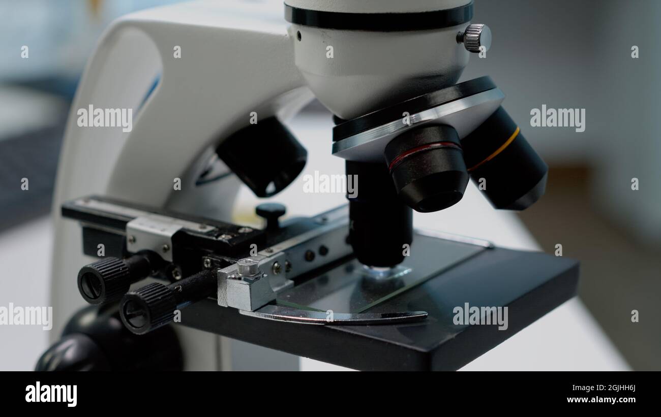 Close up of microscopic magnifying glass and lens used on blood sample ...