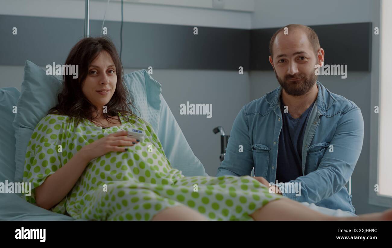 Happy family preparing for childbirth in hospital ward at maternity ...