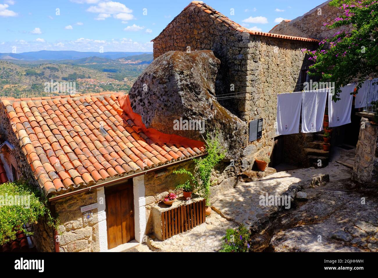 Typical traditional house built around a boulder with view over the ...