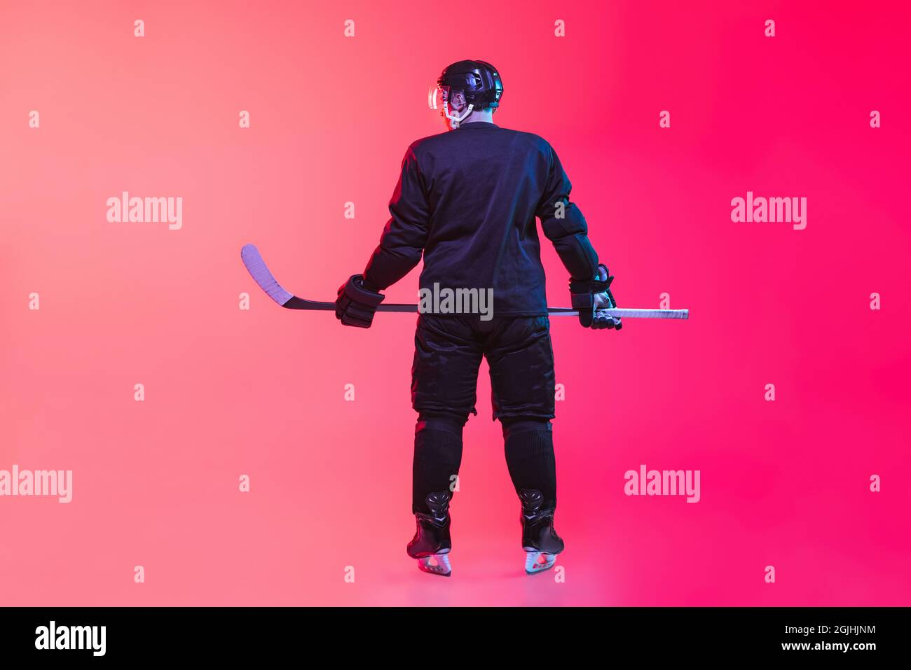Back view full-length image of professional hockey player in uniform ...