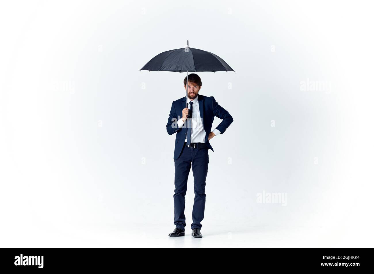 man wearing umbrella rain protection weather Stock Photo - Alamy