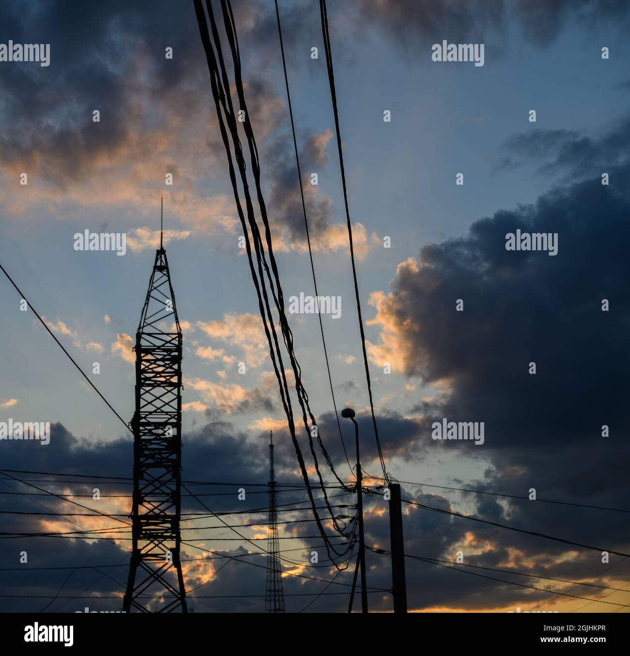 Electric post over sunset sky background Stock Photo - Alamy