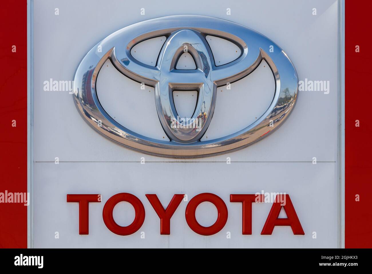 Toyota logo on car dealership building at sunny day - Toyota Motor ...