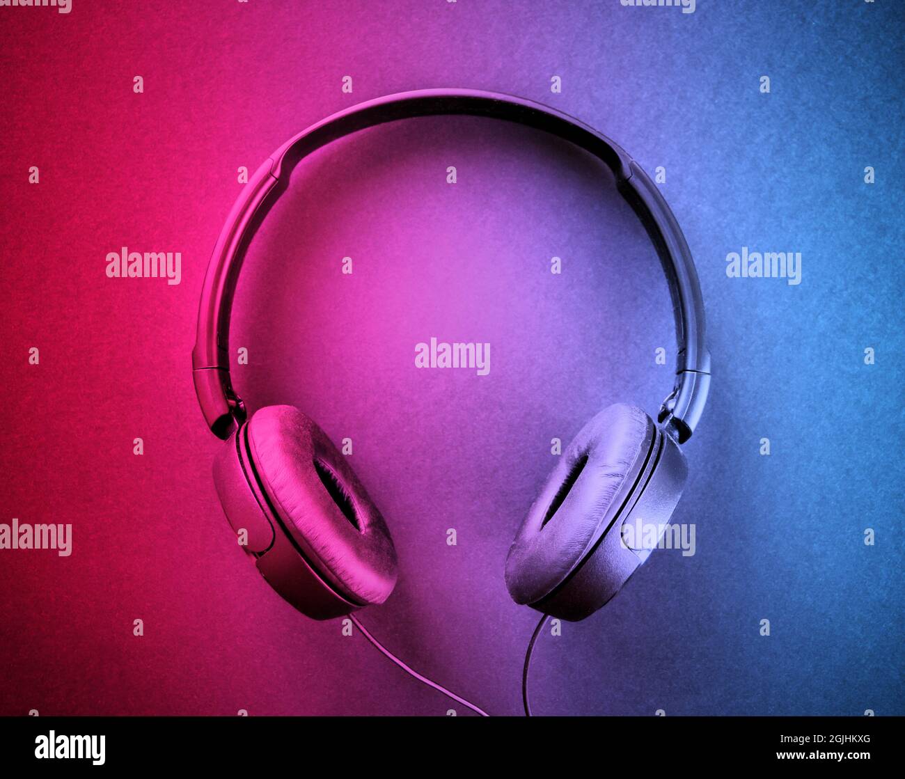 Headphones isolated on a pink to blue gradient background Stock Photo ...
