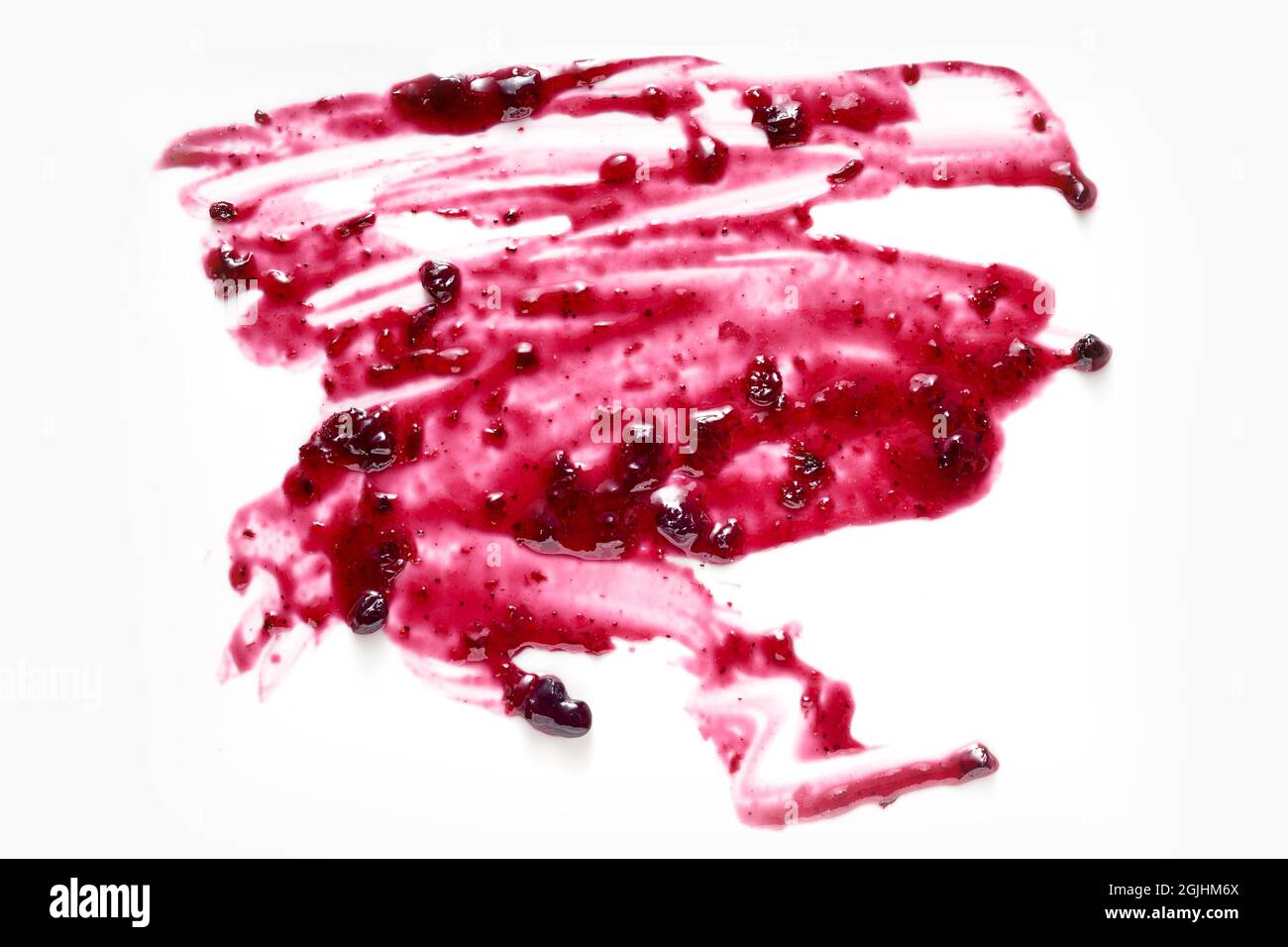 From above of sweet purple blackcurrant jam smeared on white background ...